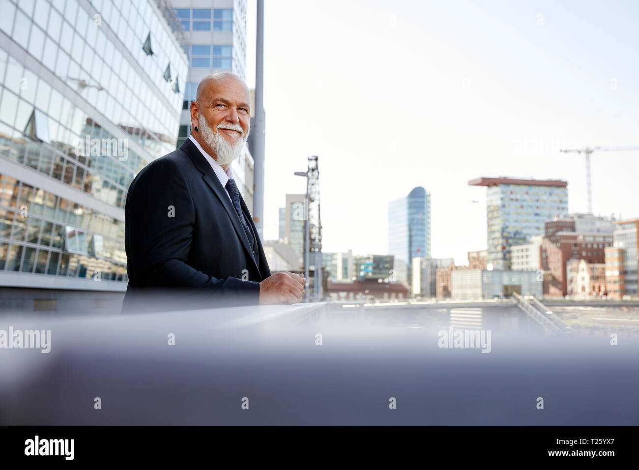 Elegant businessman leaning railing city hi-res stock photography and ...