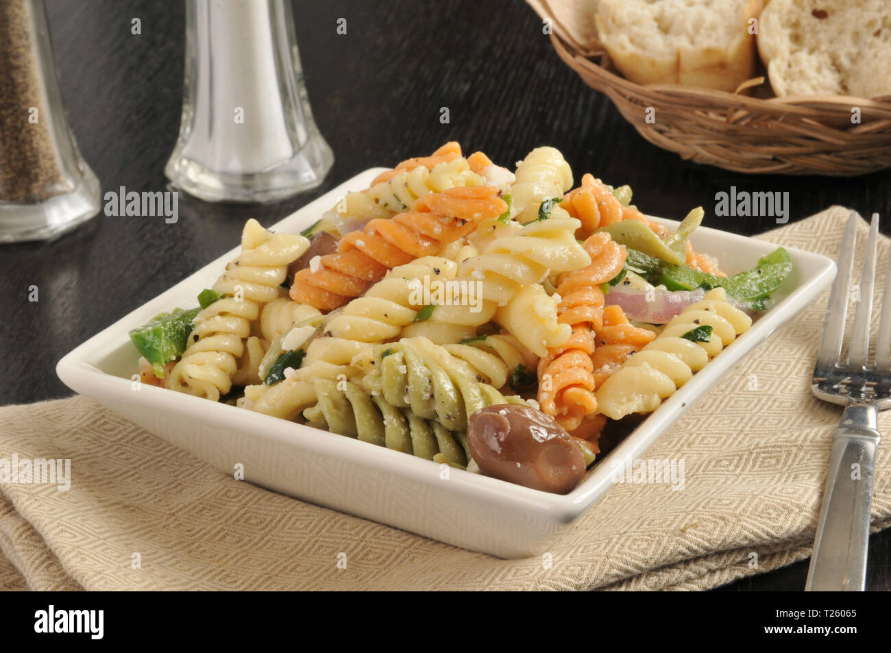 Mediterranean pasta salad with Greek olives and dinner rolls Stock ...