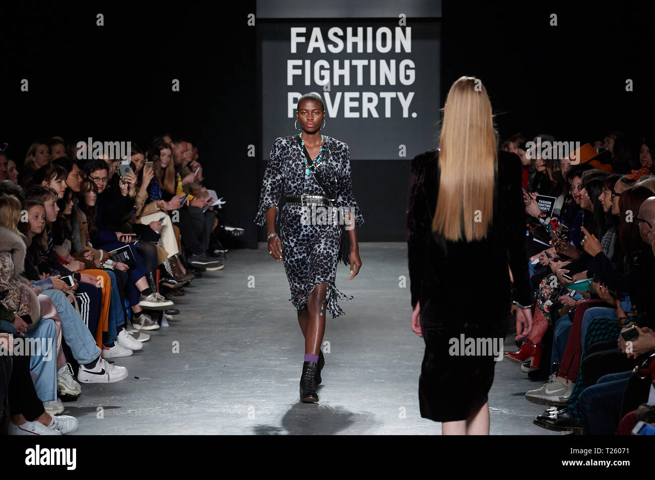 Models walking on the catwalk during the Fashion Fighting for Poverty ...