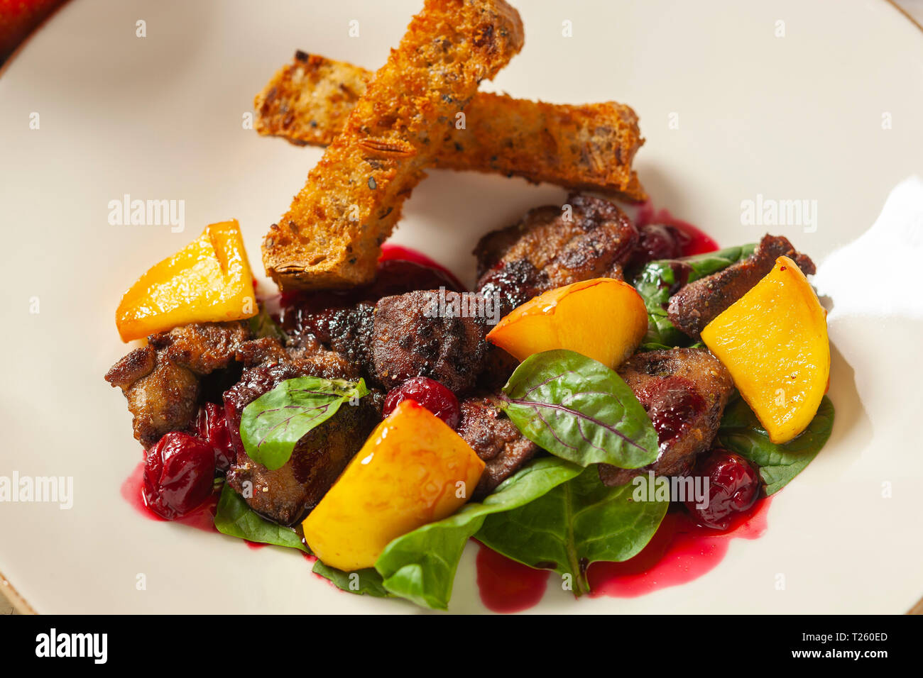 Flambéed chicken liver in Kirsch, spinach leaves, caramelized apples with garlic and rosemary ...