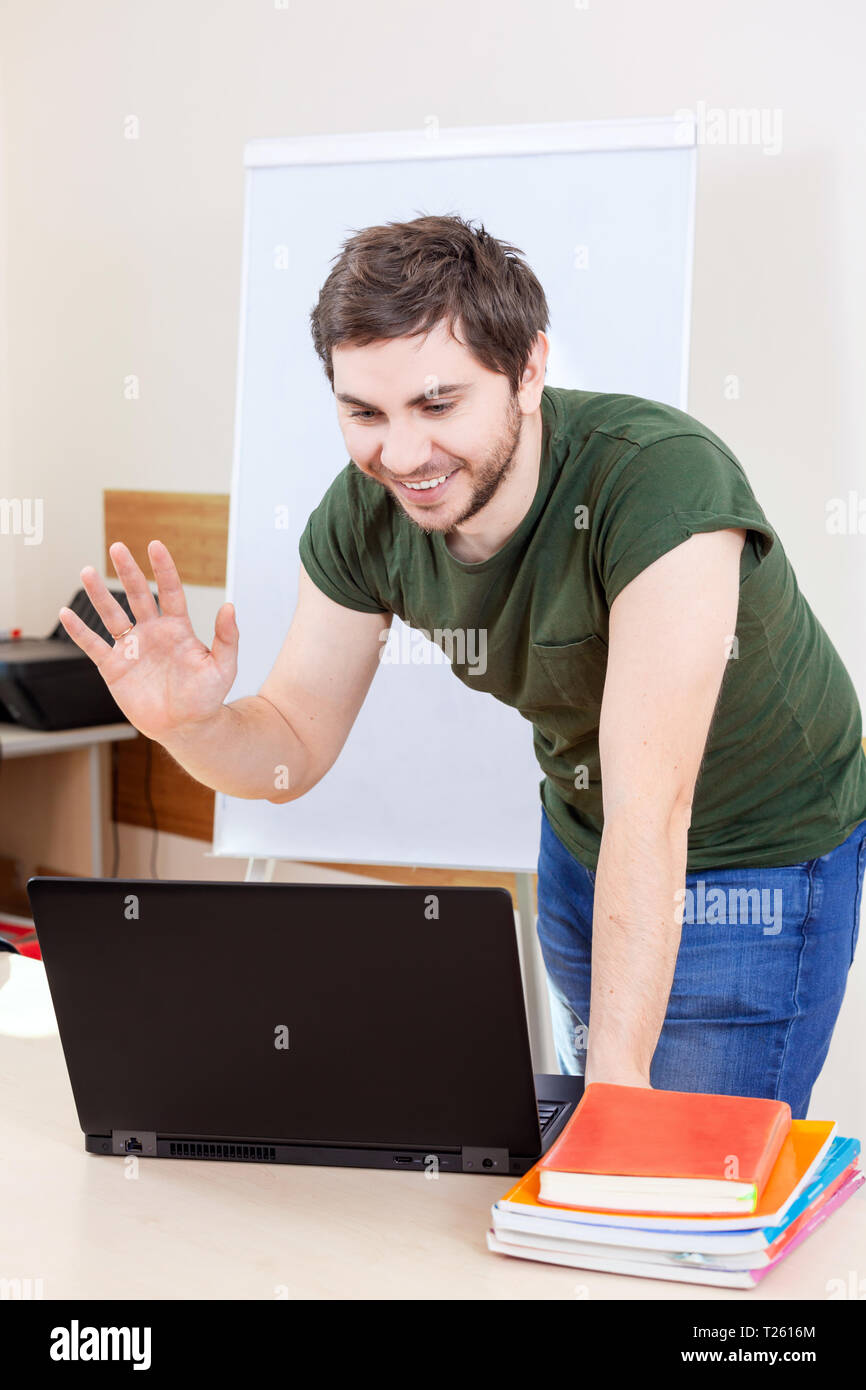 Portrait of informal male teacher in classroom on lesson. Creative ...