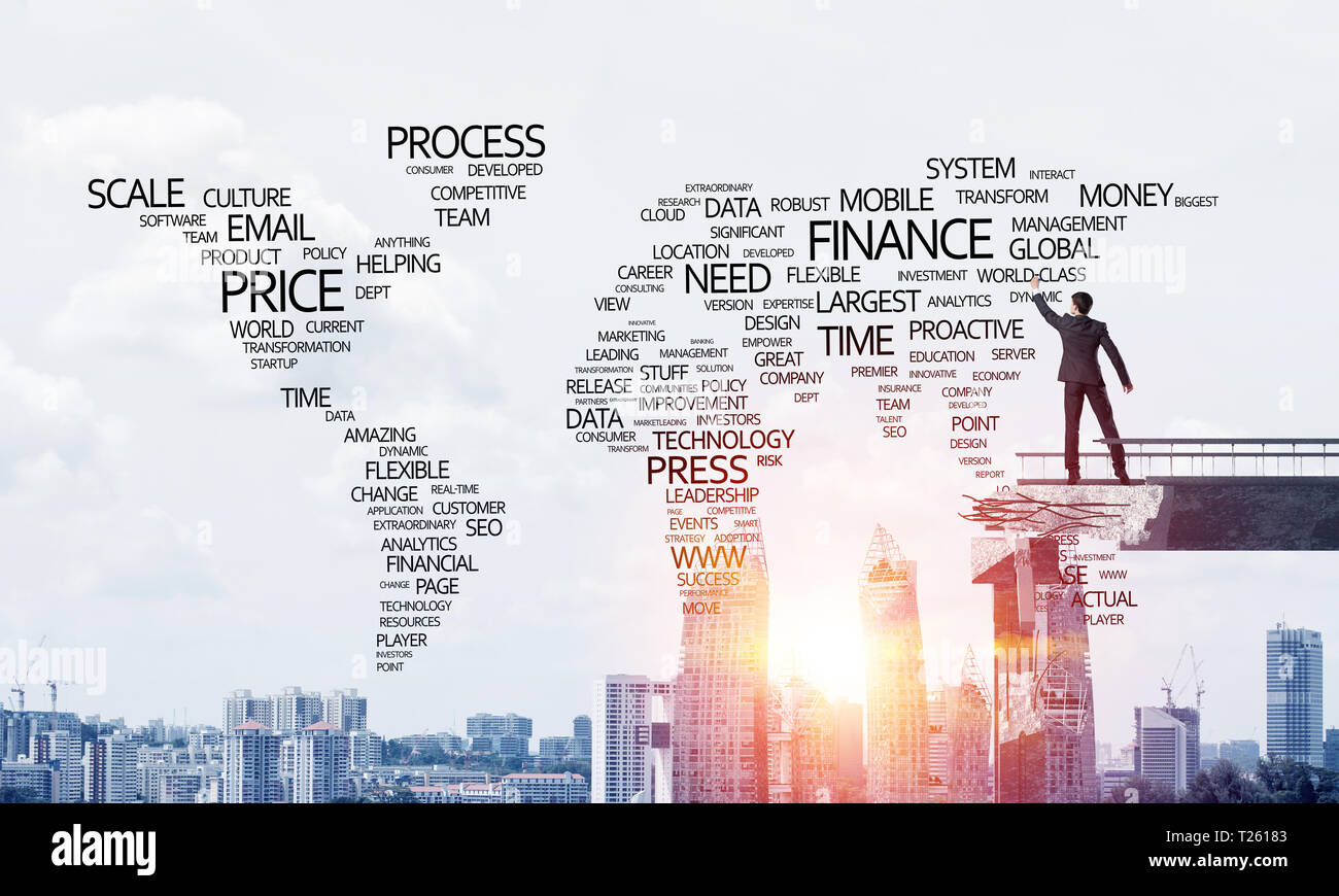 Businessman in suit writing business-related terms in form of world map ...