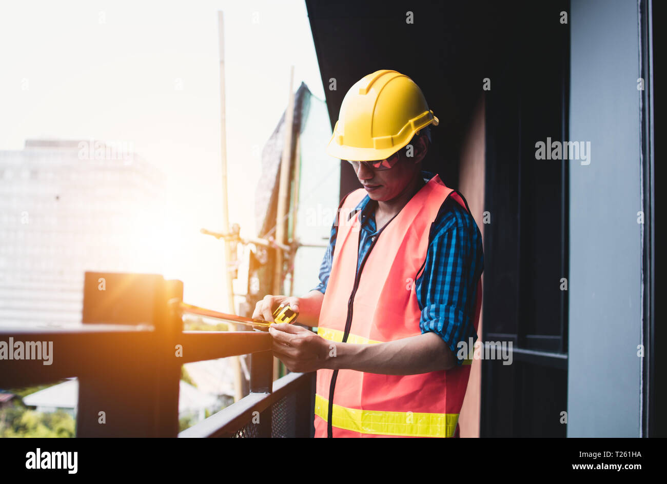 construction worker use measuring tape of balcony Stock Photo - Alamy