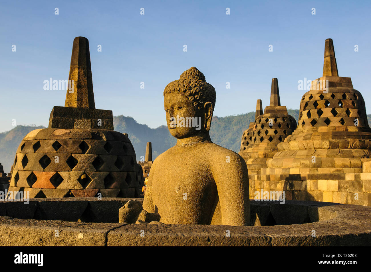 Indonesia, Java, Borobudur Temple Complex, Buddha sitting in a stupa ...