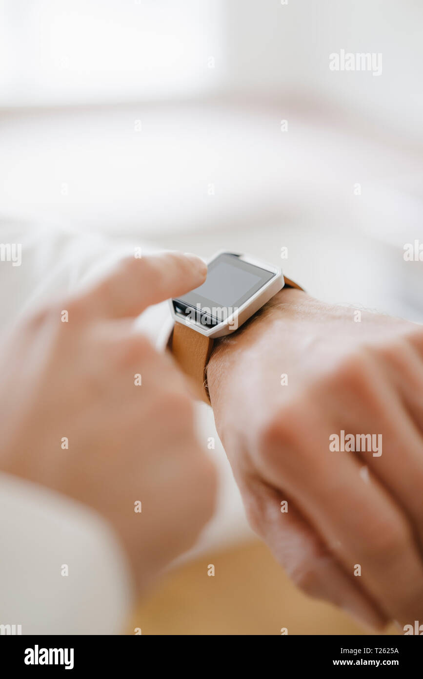 Man pointing at his smartwatch Stock Photo - Alamy