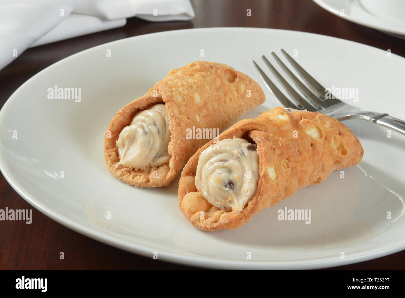 A plate of gourmet cannoli with mascarpone cheese and chocolate chips ...