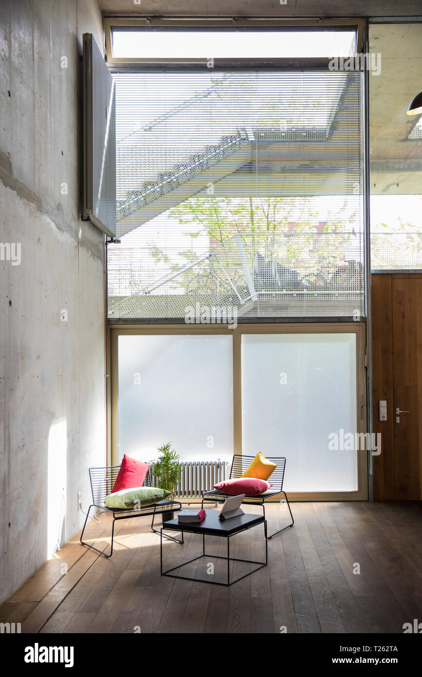 Sitting area in a loft at concrete wall Stock Photo - Alamy