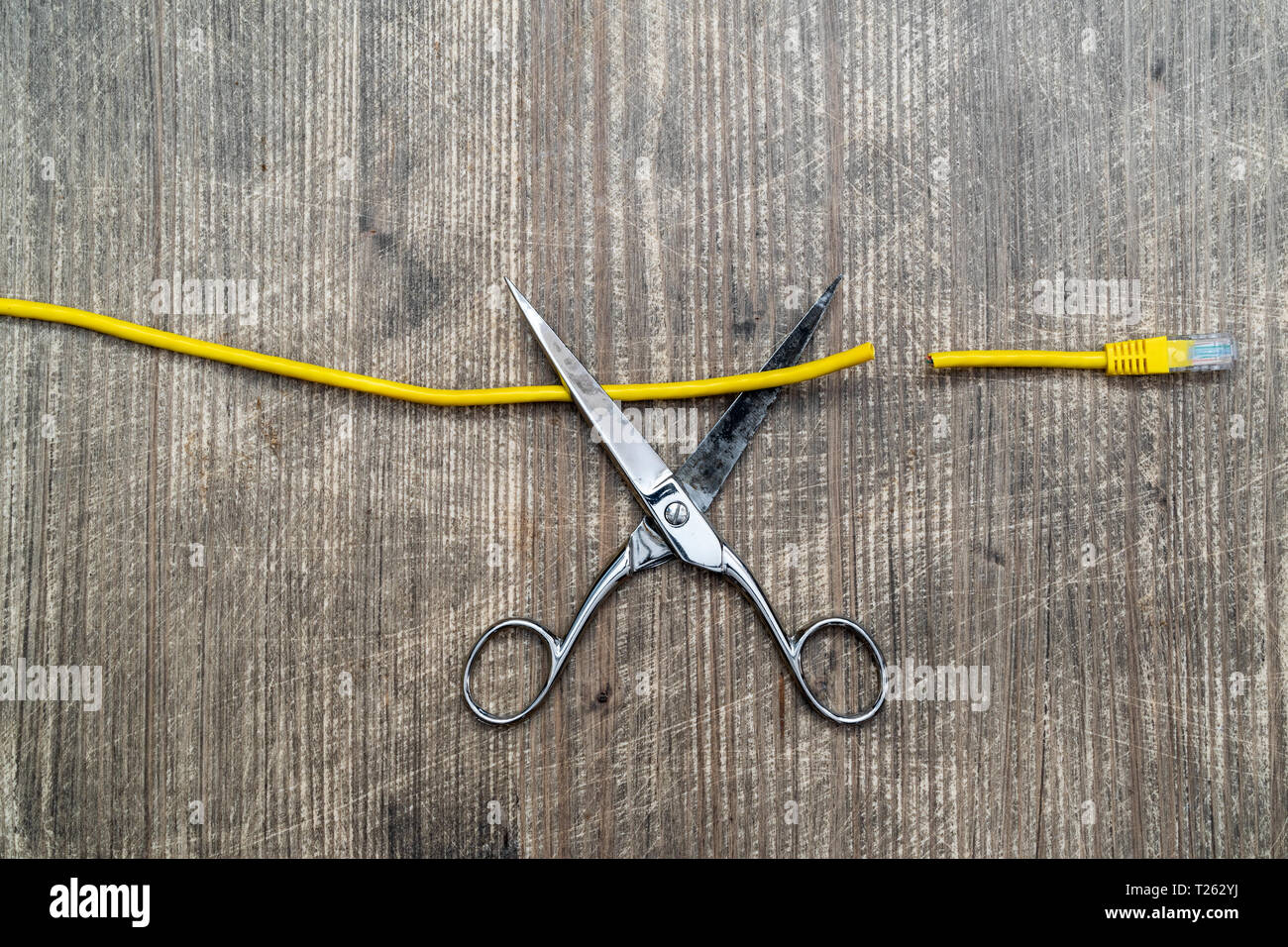 Steel scissors cut the yellow network cable connector.Internet ...