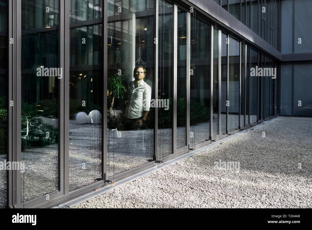 Office building man window hi-res stock photography and images - Alamy