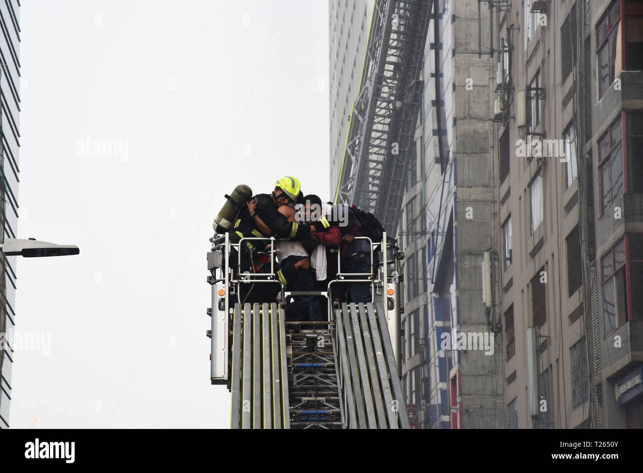 Bangladeshi Firefighters rescue people from a burnt office building in ...