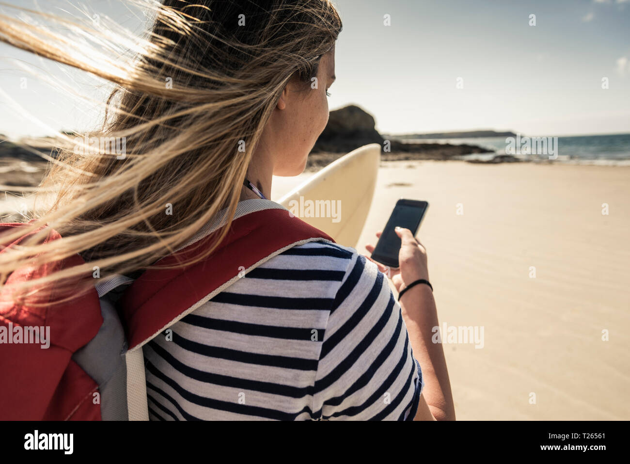 Young woman beach carrying surfboard hi-res stock photography and ...