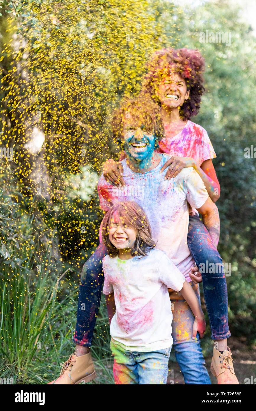 Family full of colorful powder paint, celebrating Holi, Festival of ...