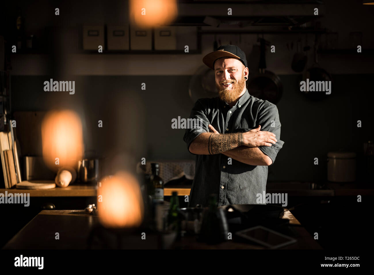 Proud hobby chef standing in his kitchen, with arms crossed Stock Photo ...