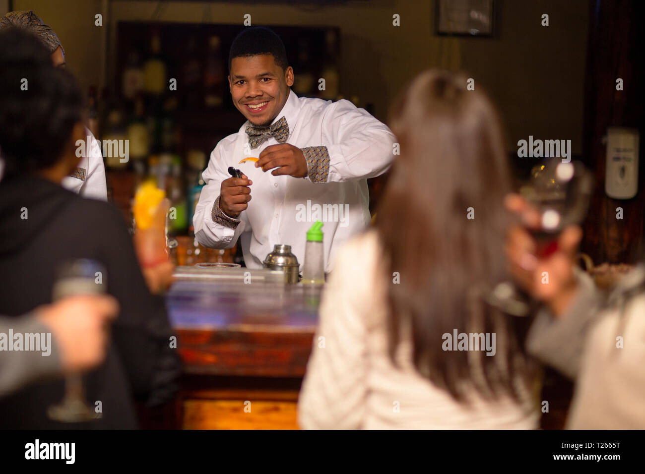 Bartender making drinks in a bar Stock Photo - Alamy