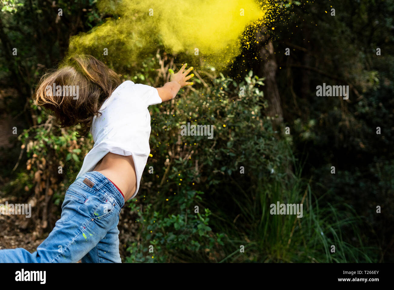 Boy throwing colorful powder paint, celebrating Holi, Festival of ...