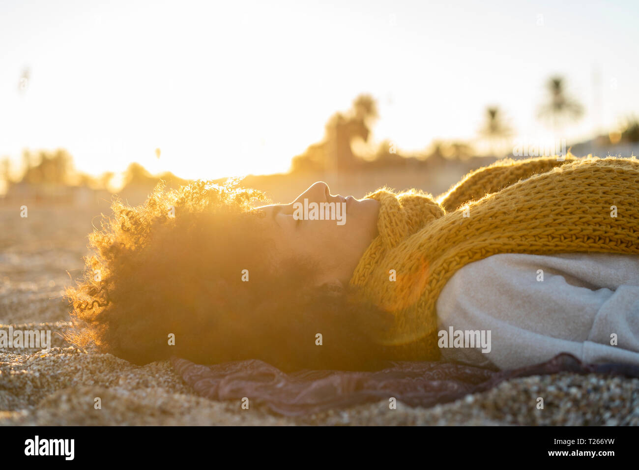 Woman lying in the sand, relaxing on the beach Stock Photo - Alamy