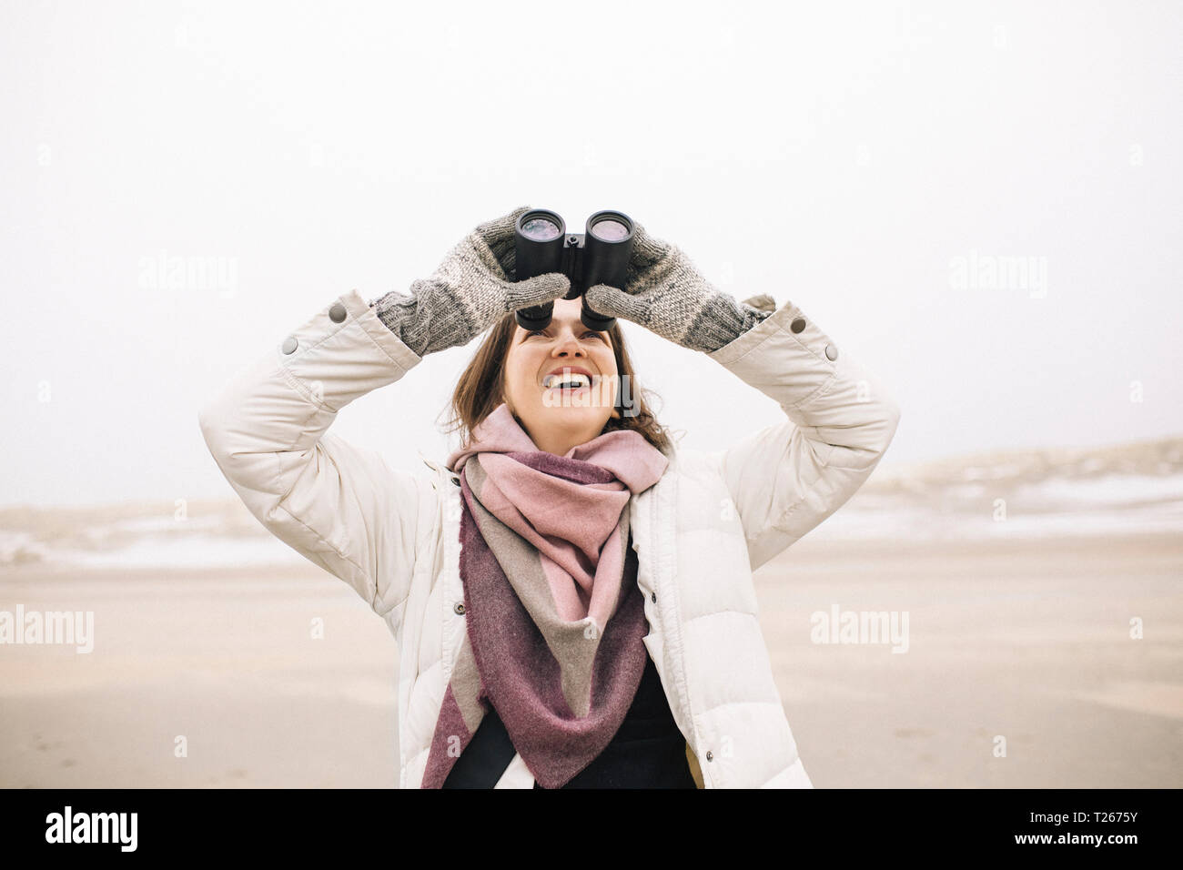 Woman using binoculars beach hi-res stock photography and images - Alamy