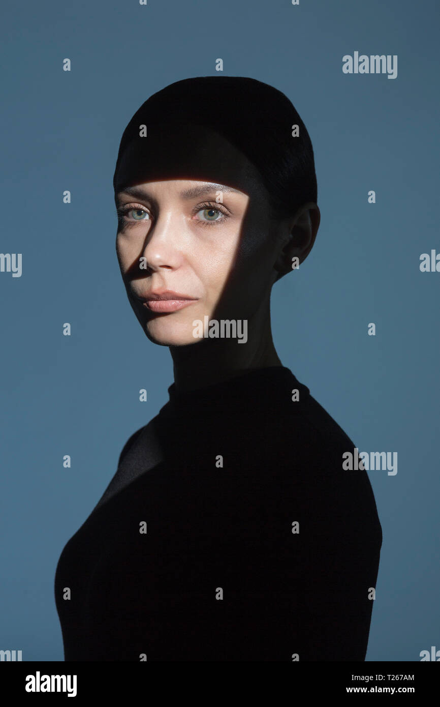 Portrait of woman with shadow and light on her face Stock Photo - Alamy