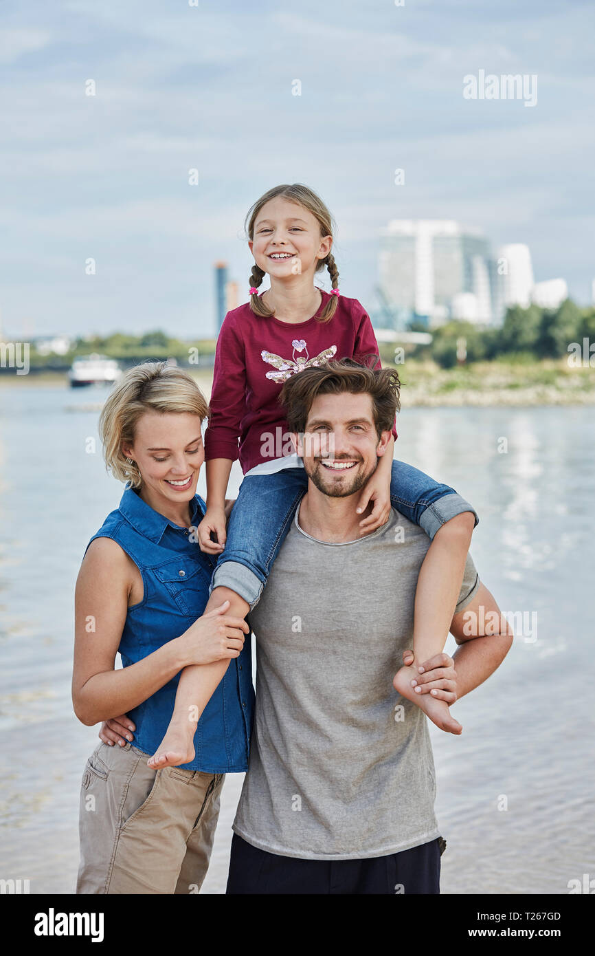 Germany, Duesseldorf, happy family with daughter at Rhine riverbank ...