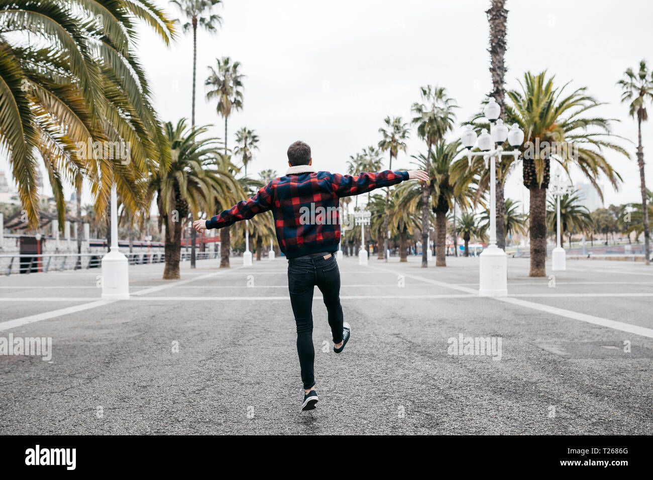 Back view of a young man wearing casual clothes jumping Stock Photo - Alamy