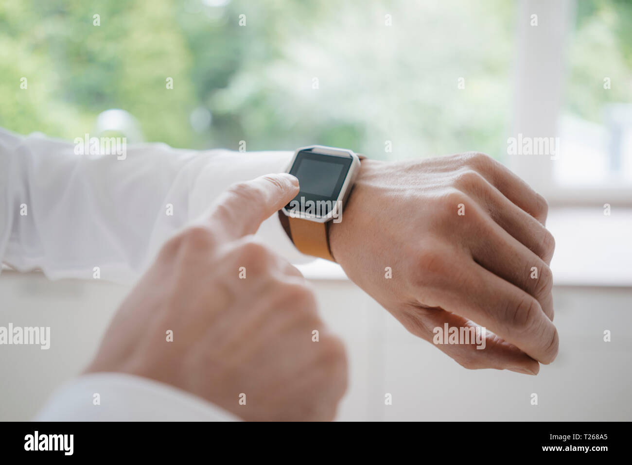Man pointing at his smartwatch Stock Photo - Alamy