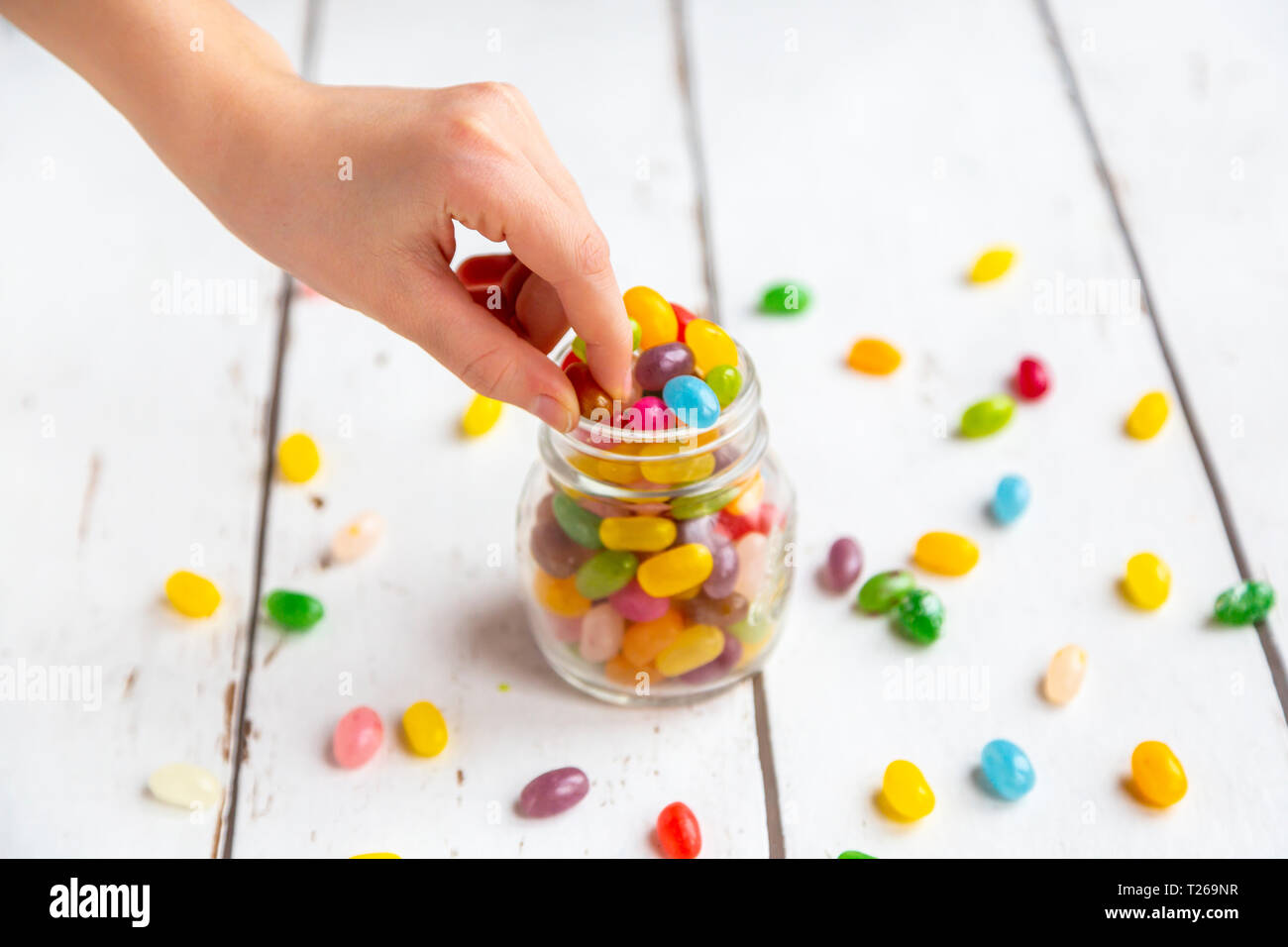 Hand taking sweet hi-res stock photography and images - Alamy