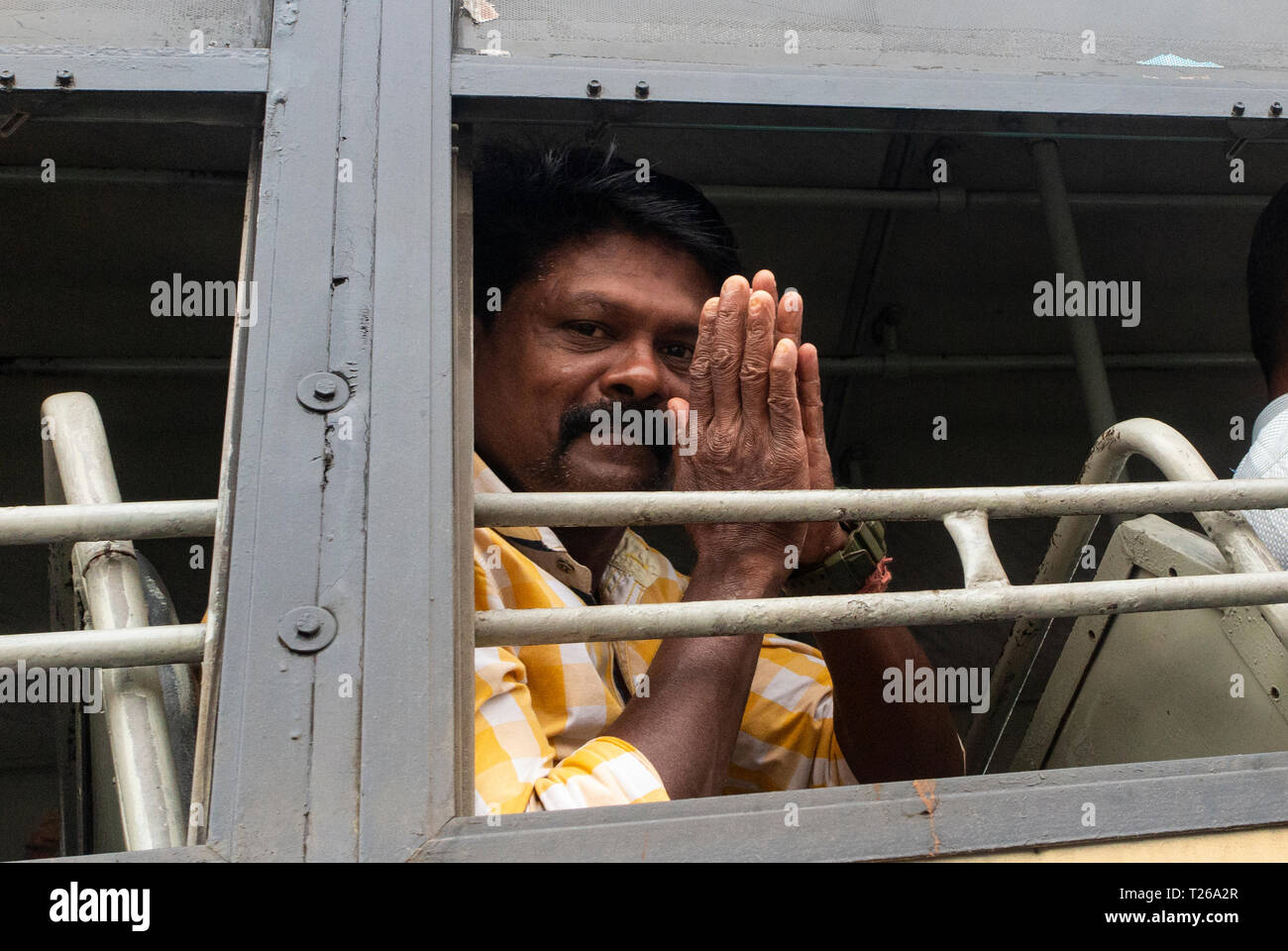 A smiling man offers a prayer symbol from an Indian bus Stock Photo - Alamy