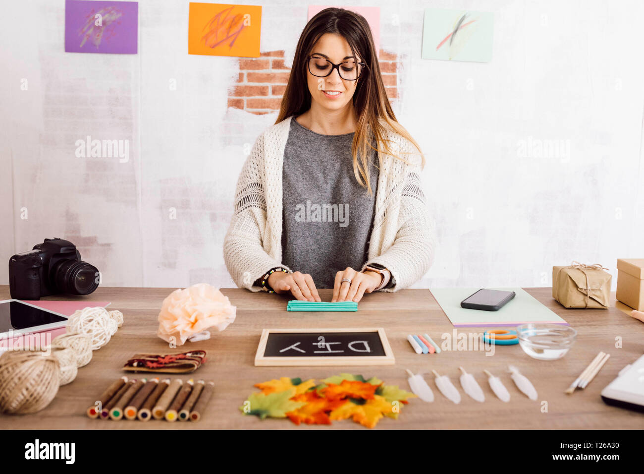 Young woman doing crafts at home, paper flowers Stock Photo - Alamy