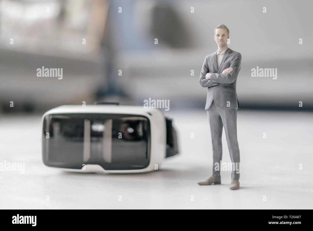 Miniature businessman figurine standing next to VR glasses Stock Photo ...