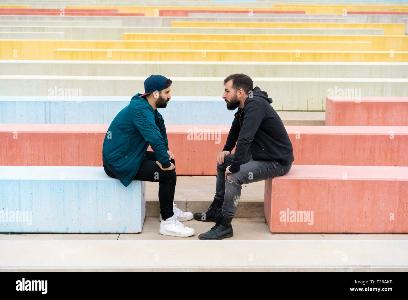 Sitting on benches hi-res stock photography and images - Alamy