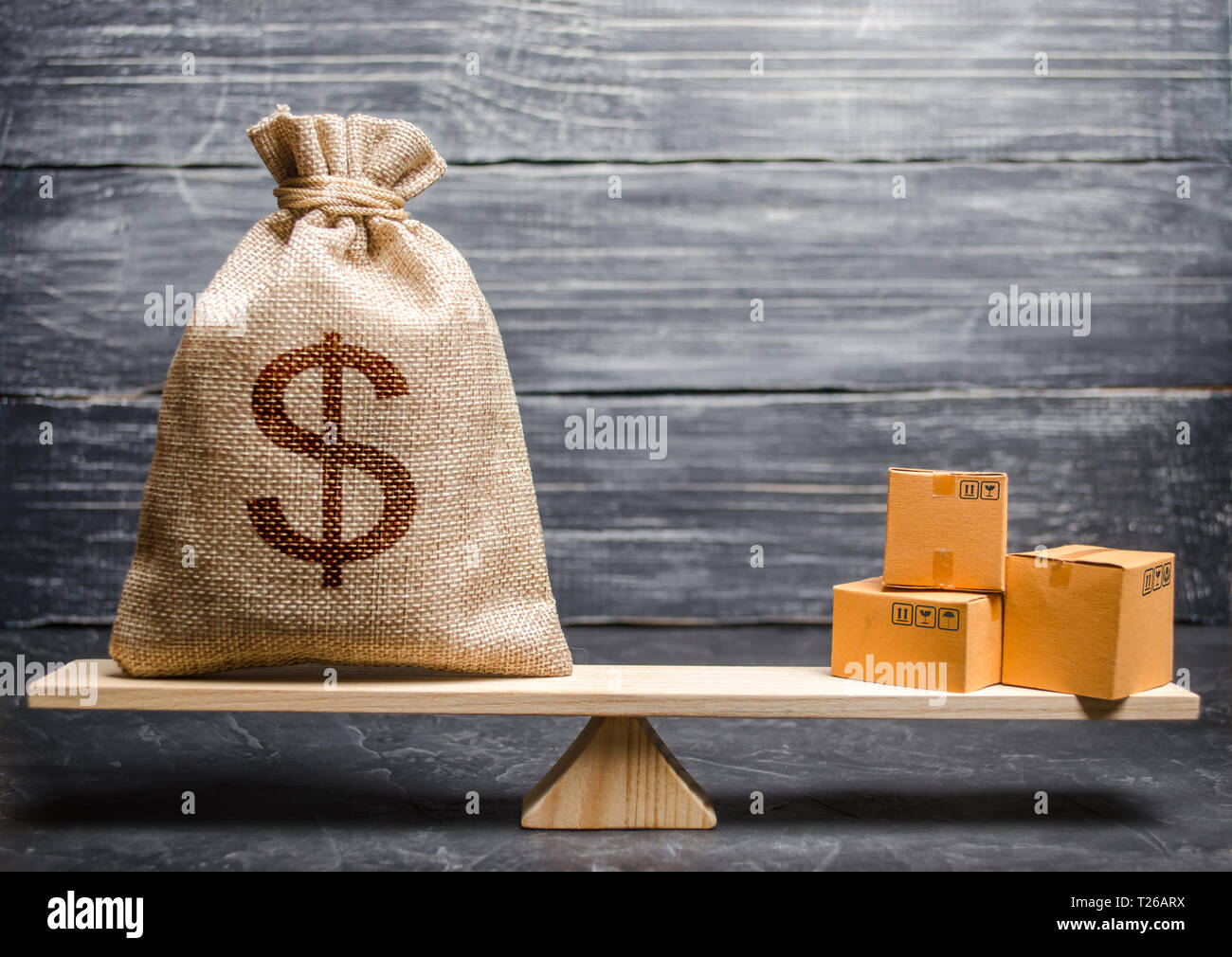 A bag of money and a bunch of boxes on the scales. Conceptual trade ...