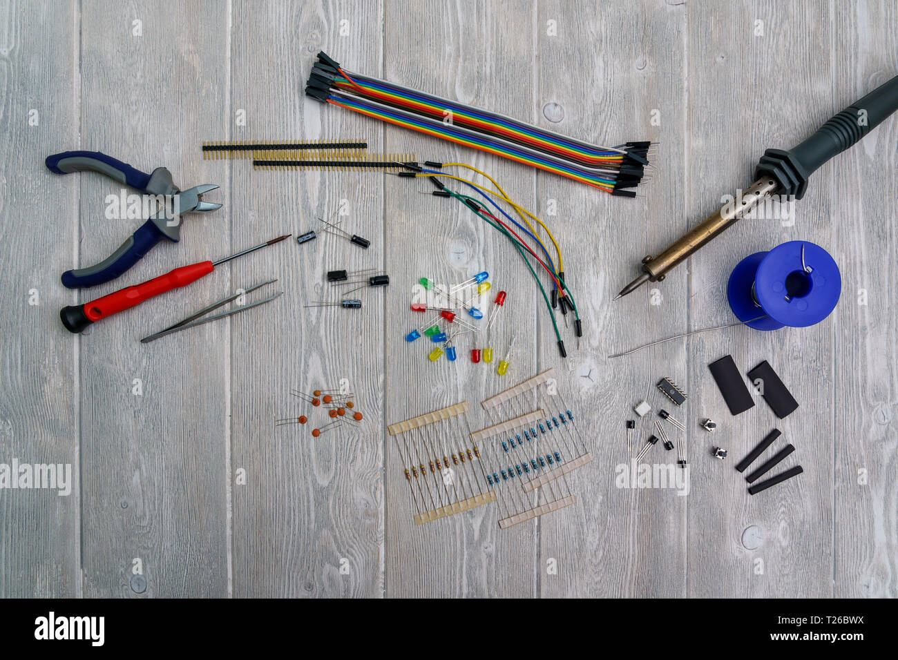 leds, resistors and electronic components with tools on a white vintage ...