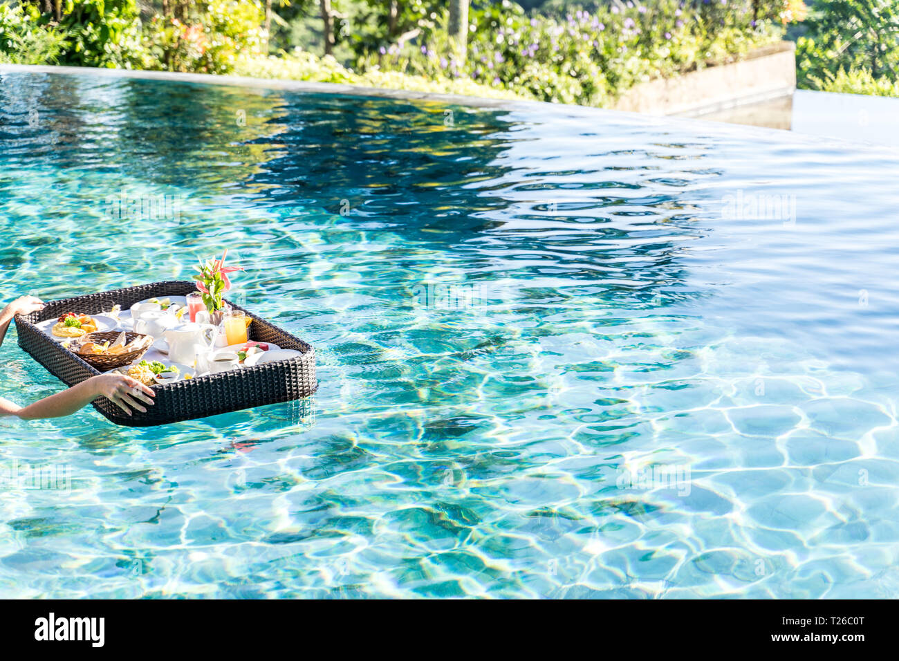 Floating breakfast in infinity pool on paradise island Bali. Luxury ...
