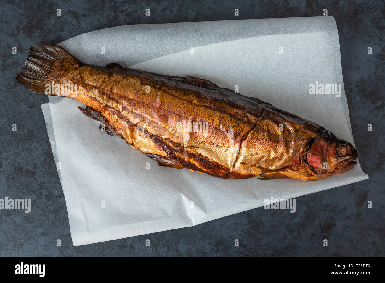 Smoked trout fish on a dark background Stock Photo - Alamy