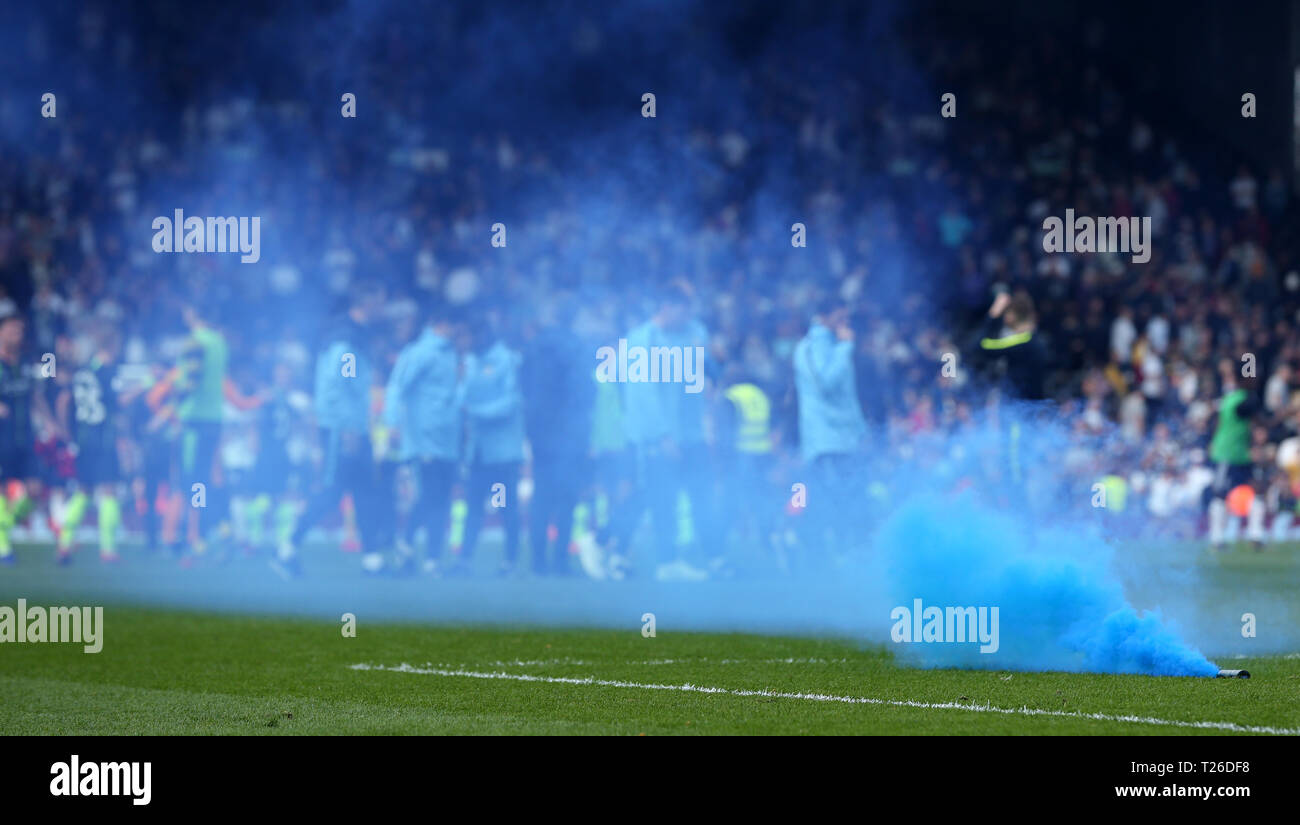 A blue flare on the pitch after the Premier League match at Craven ...