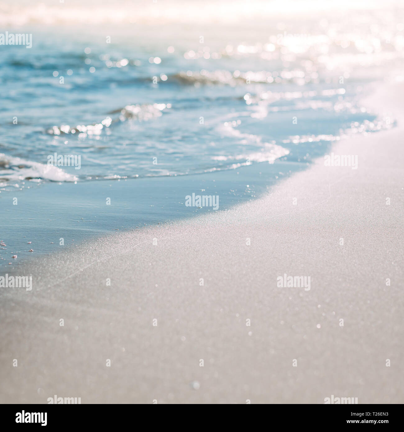 Summer sand beach and seashore waves background. Defocused blurred ...