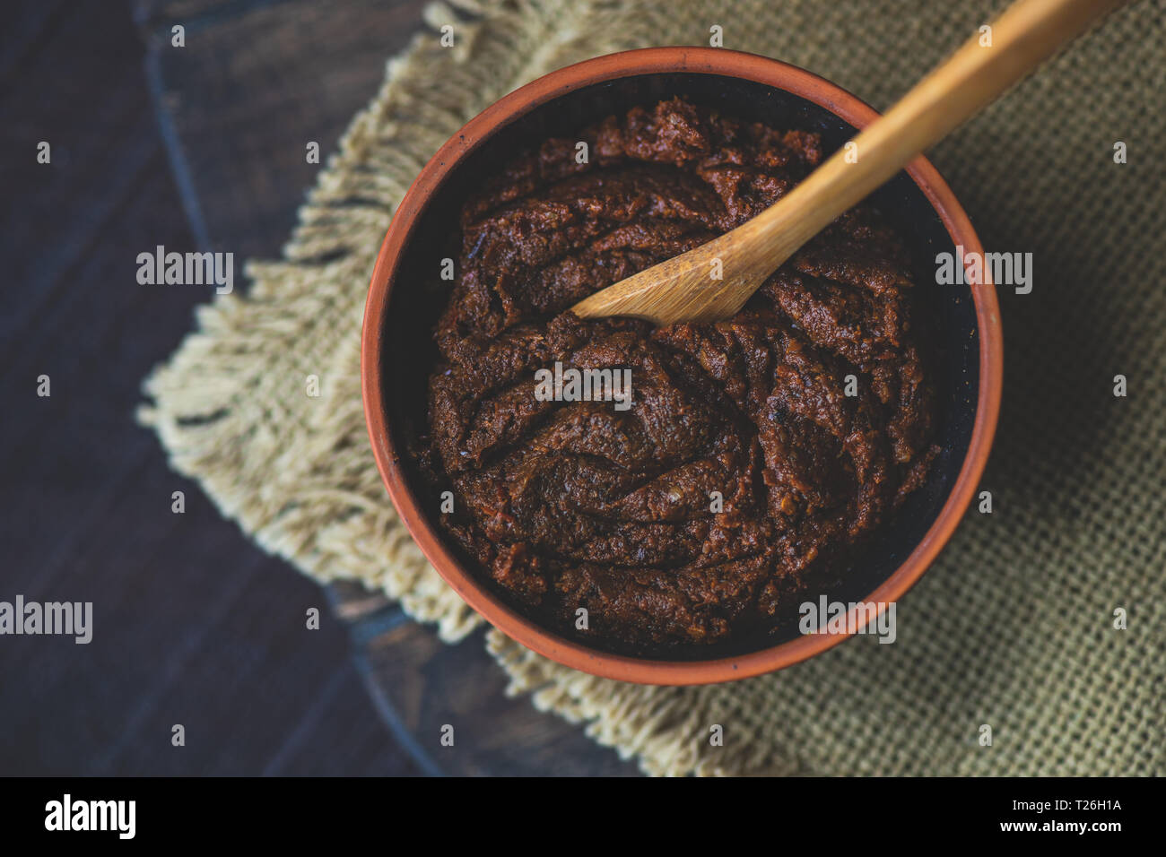 Traditional georgian sauce spicy ajika on rustic background with copy ...