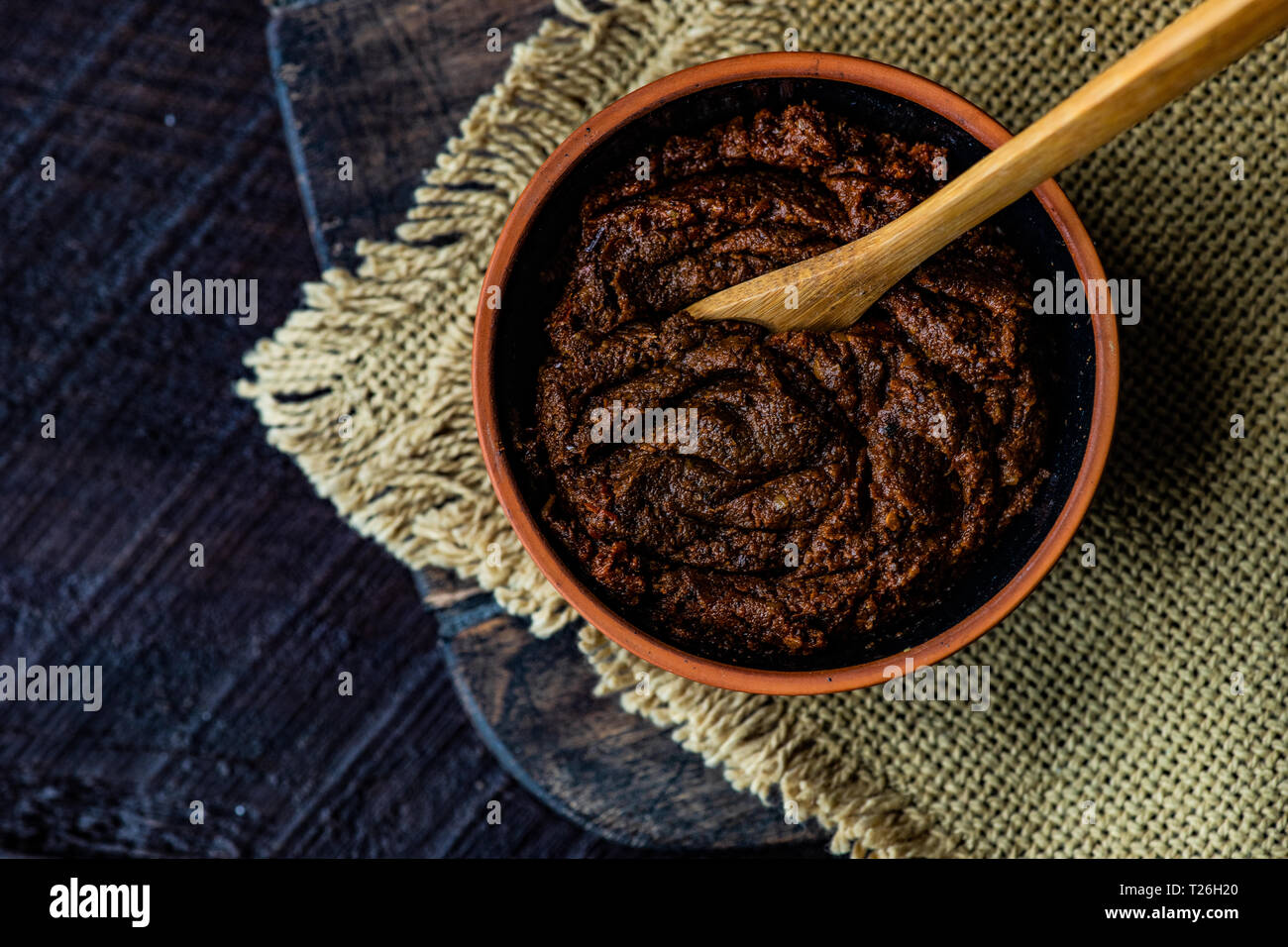 Traditional georgian sauce spicy ajika on rustic background with copy ...