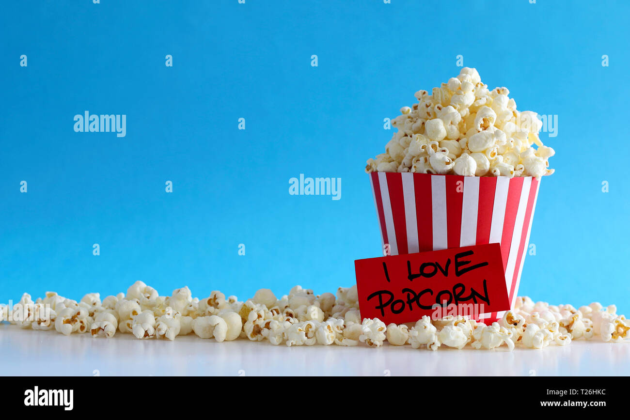 Delicious popcorn in classic red and white paper striped bag with label ...