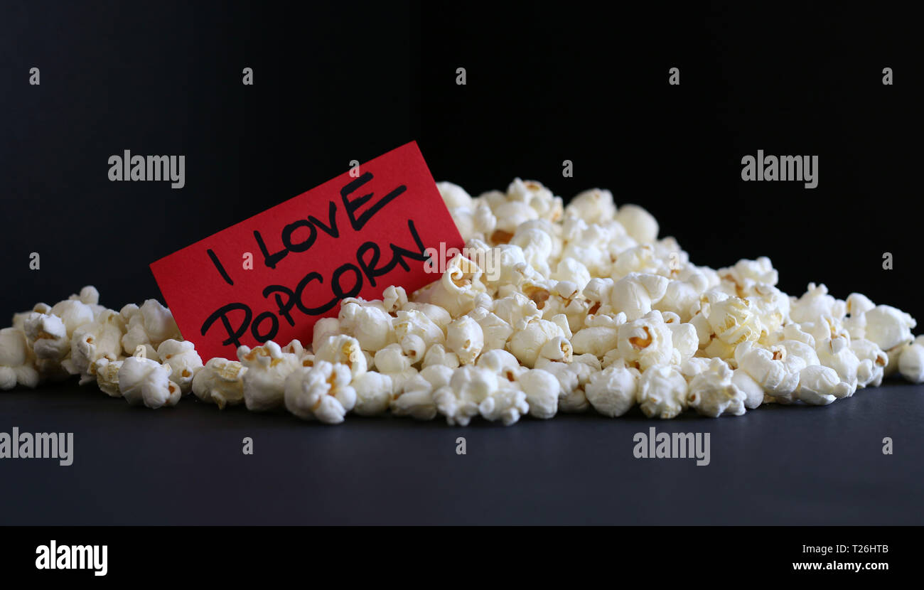 Popcorn with tag - I love popcorn isolated on dark background Stock ...