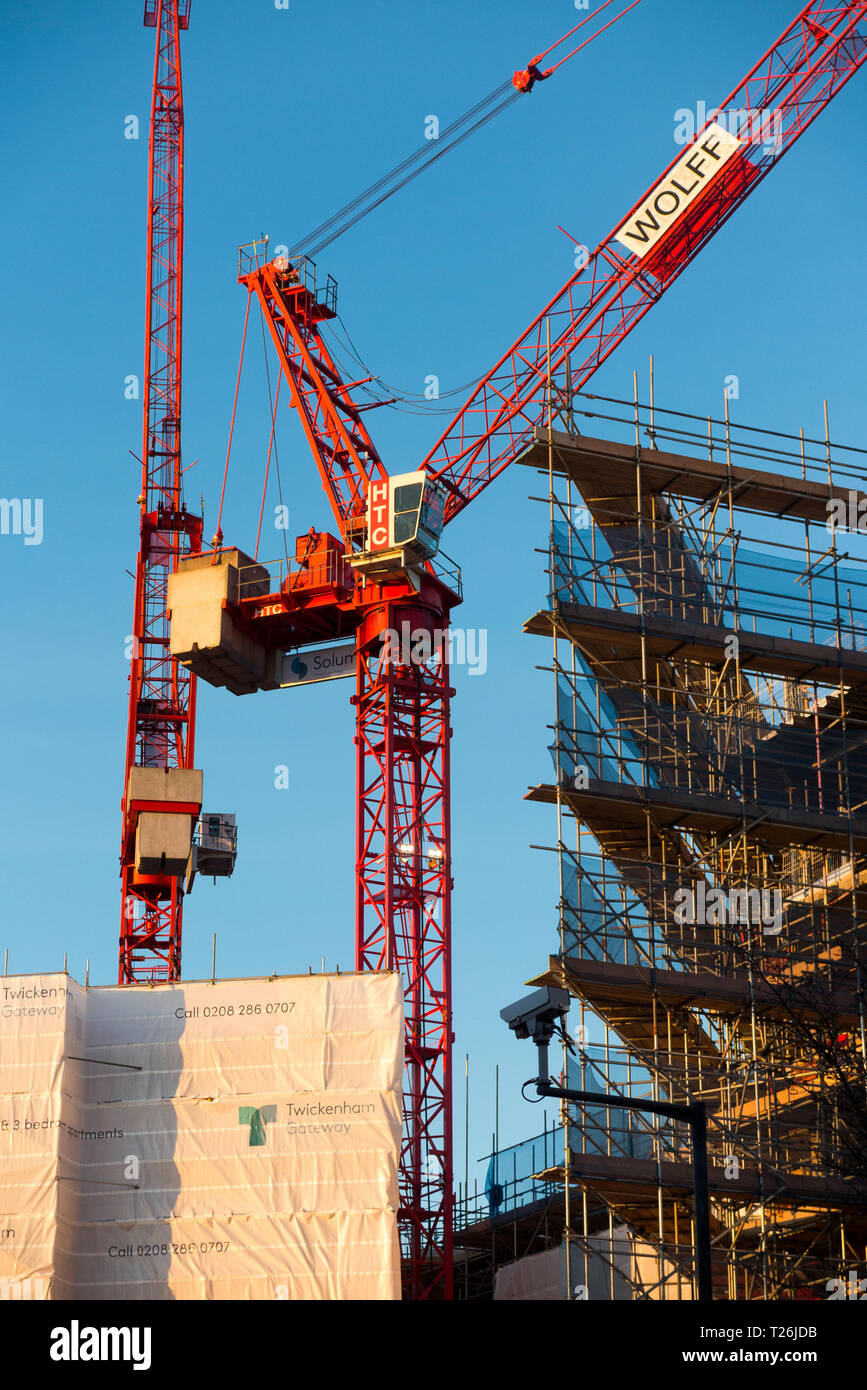 Construction site with 2 / two luffing jib tower cranes at work ...