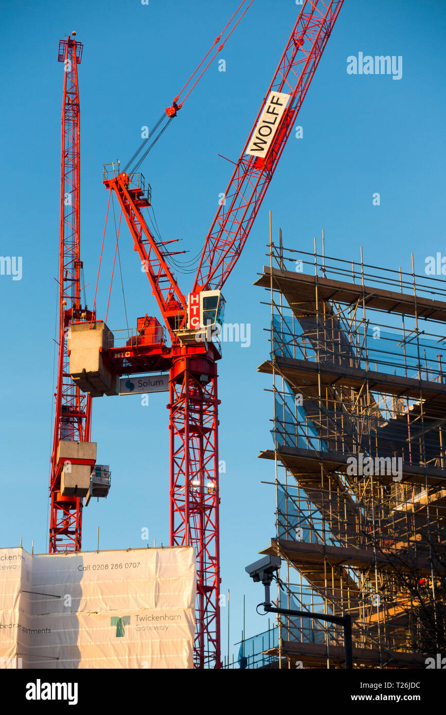 Construction site with 2 / two luffing jib tower cranes at work ...