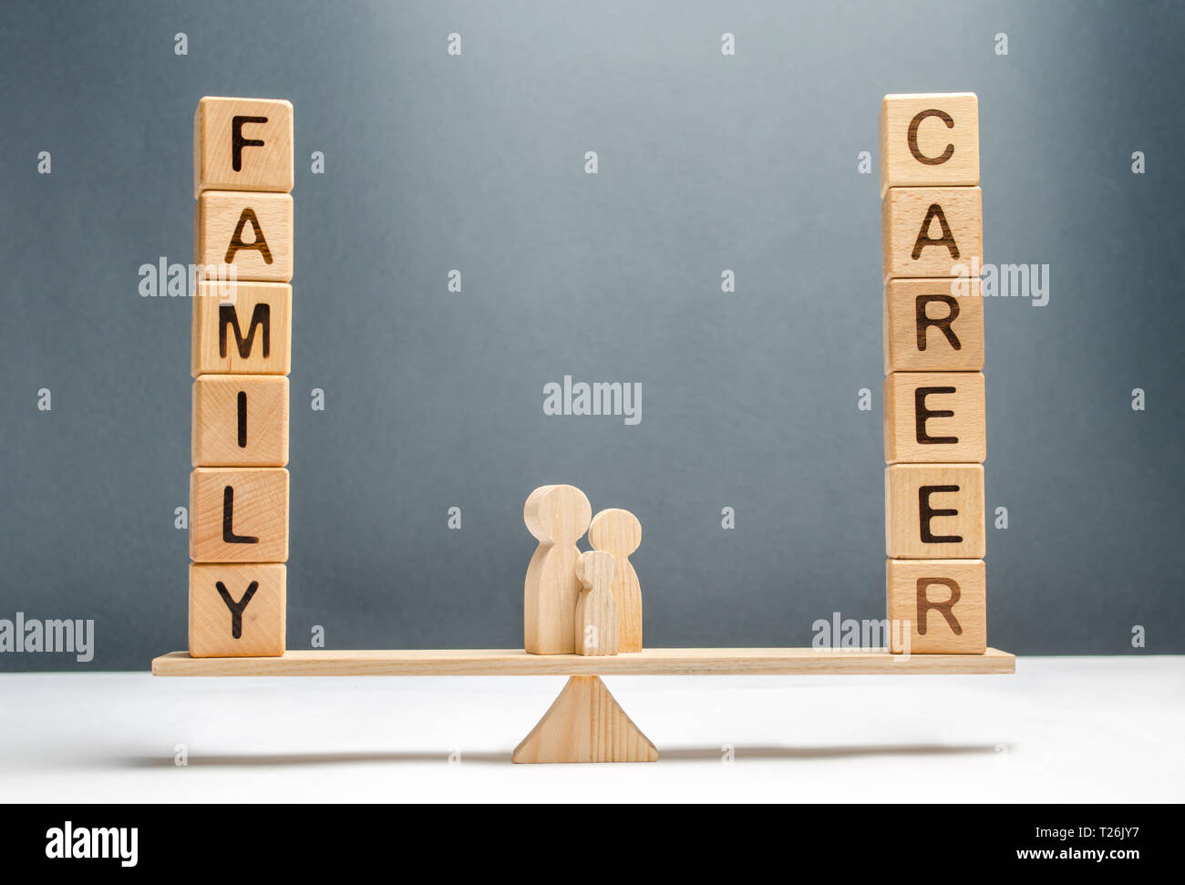 Family figures stand on scales between career and family. Conceptual ...