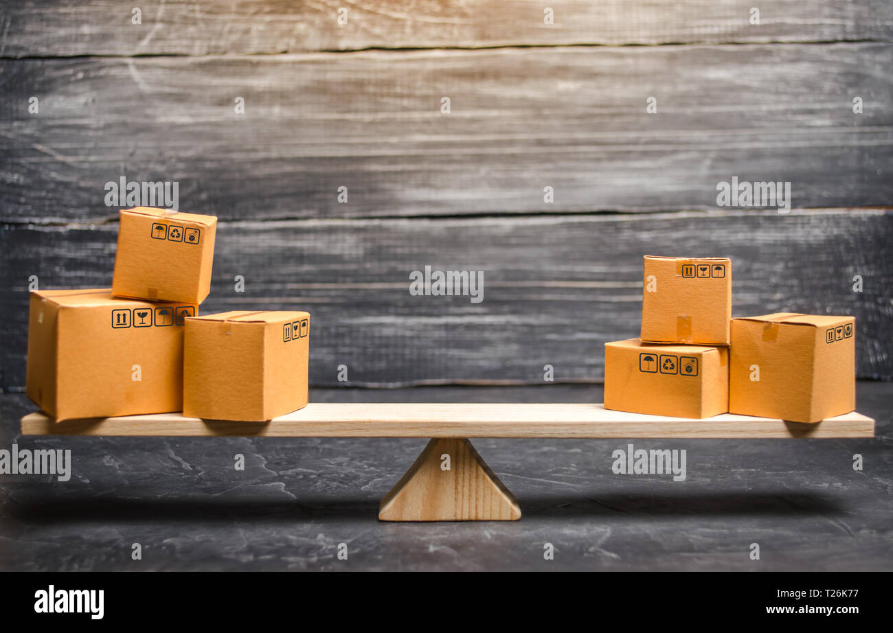 Two piles of boxes on the scales. Trade balance and calculation by ...