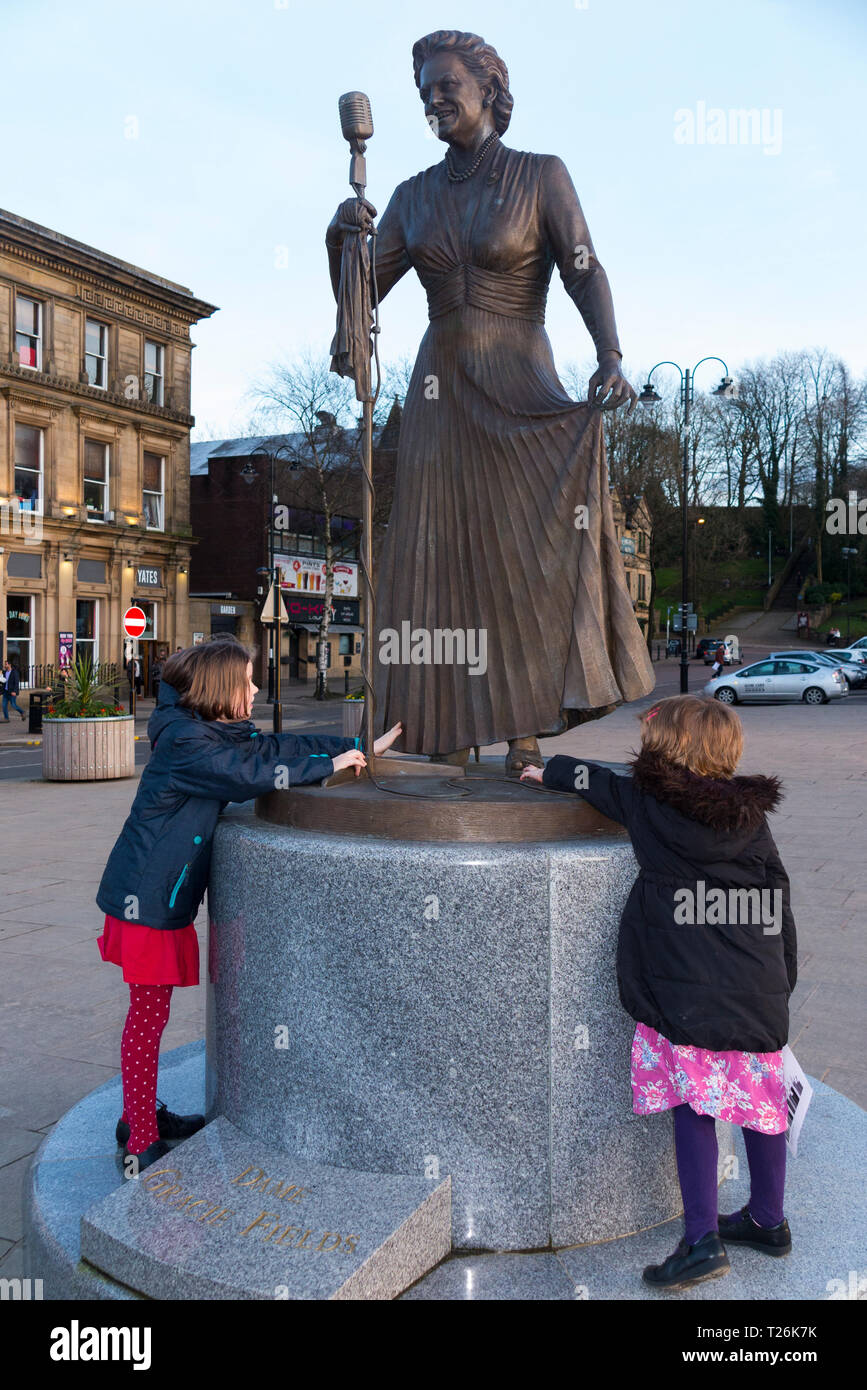 Two children / kids / girls admire the statue of Dame Gracie Fields ...