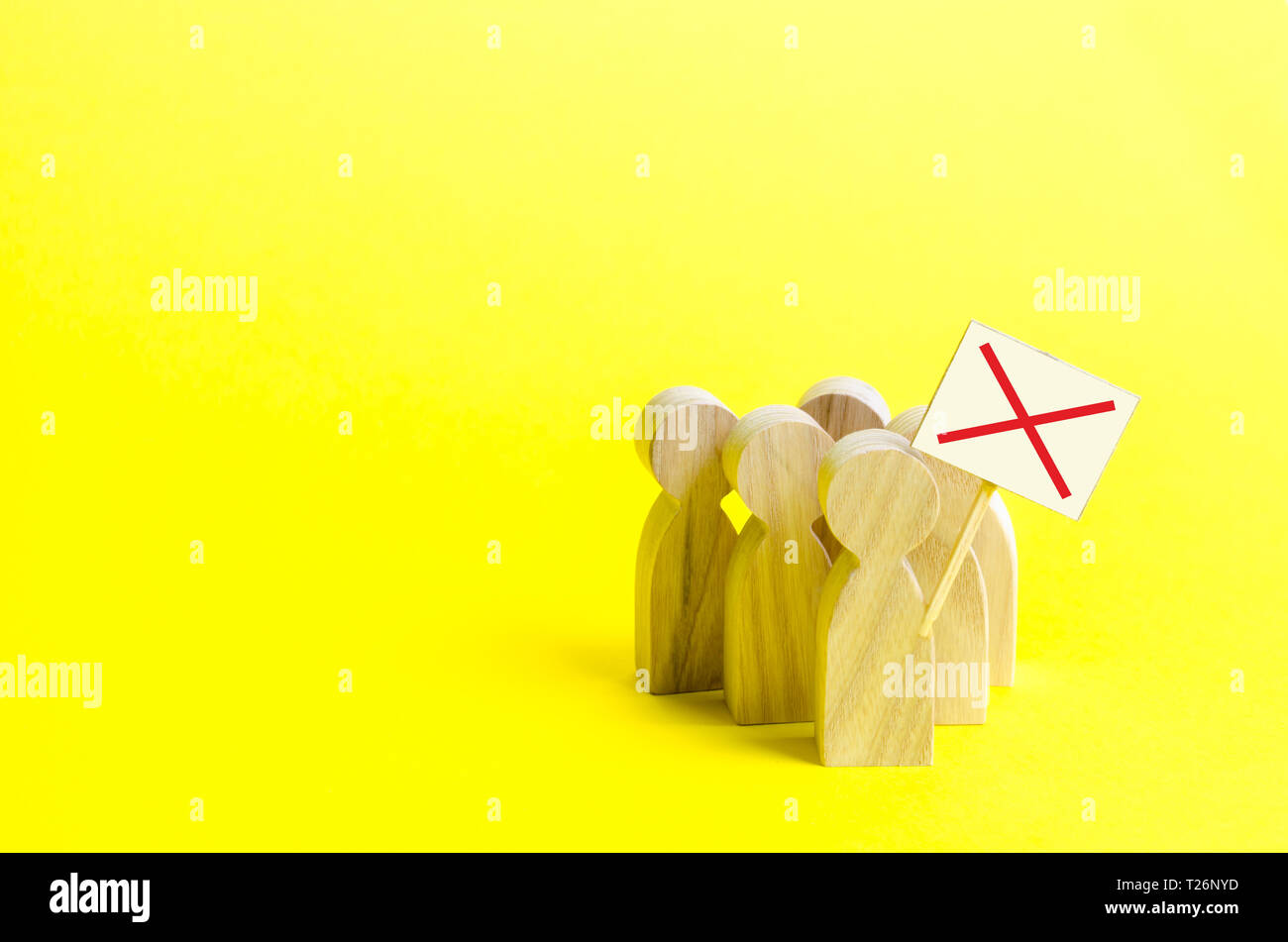 A group of protesting figures with signs on an yellow background. An ...