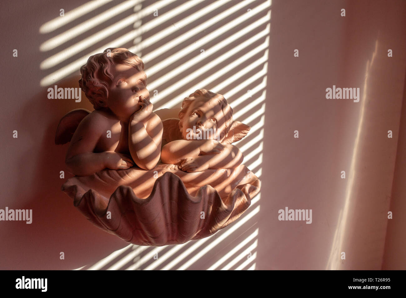 Two pretty Cherubs leaning on their arms and looking out as they lean ...