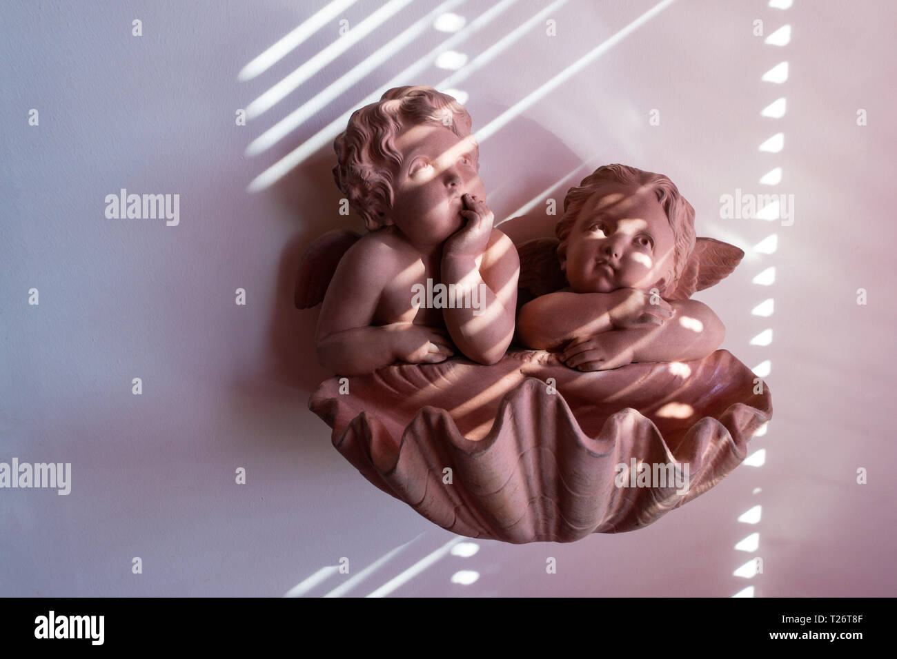 Two pretty Cherubs leaning on their arms and looking out as they lean ...