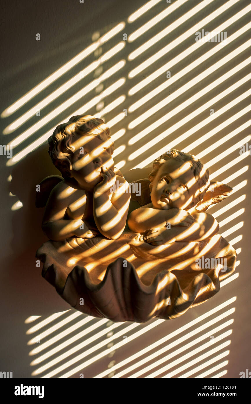 Two pretty Cherubs leaning on their arms and looking out as they lean ...