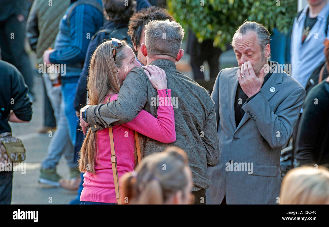 Essex, UK. 30th March 2019. Mourners comfort each other after leaving ...